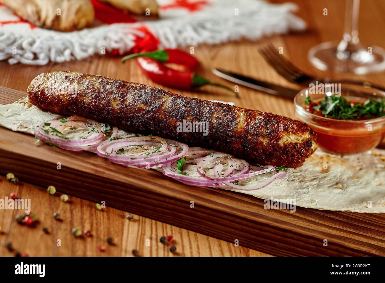 Chicken lule kebab with lavash, onion, greens and satsebeli Stock Photo ...
