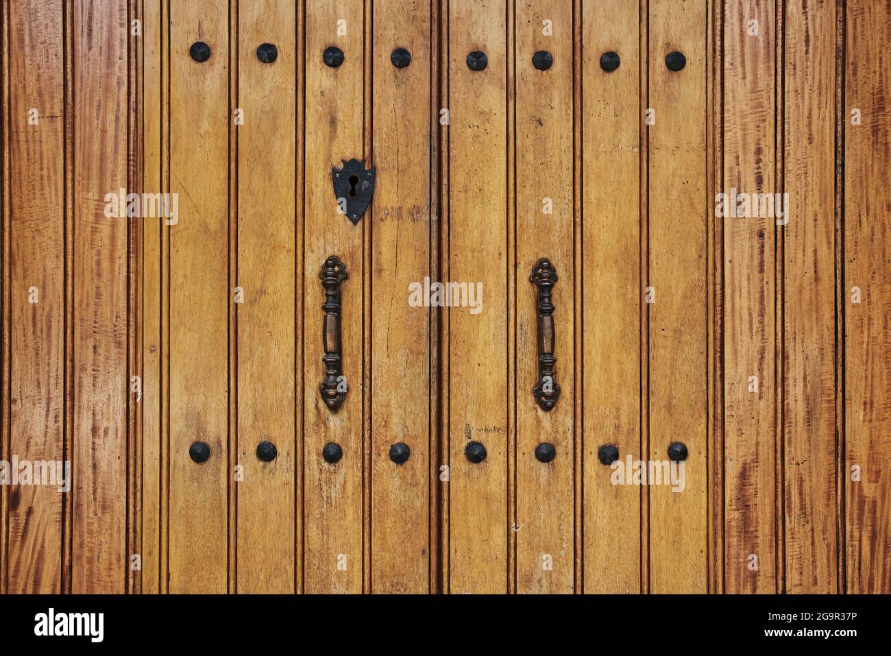 Antique wooden door with rusted hardware Stock Photo - Alamy