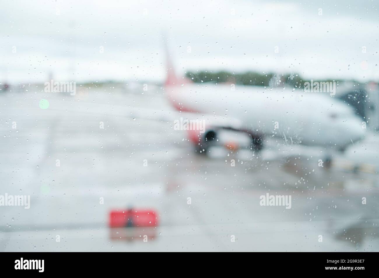 An airplane outside the airport window Stock Photo - Alamy