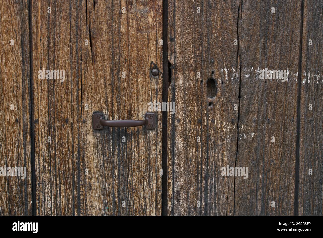 Antique wooden door with rusted hardware Stock Photo - Alamy