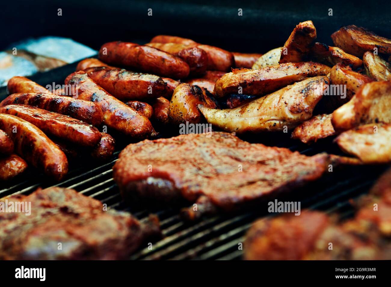 Meat and potatoes on BBQ, barbecue grill Stock Photo - Alamy