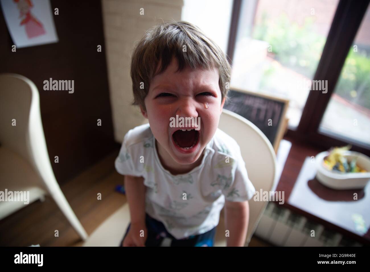 High angle view of a boy crying sitting on a chair at home Stock Photo ...