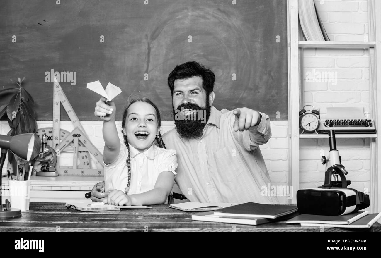 Man bearded pedagogue and pupil having fun. School learners leisure ...