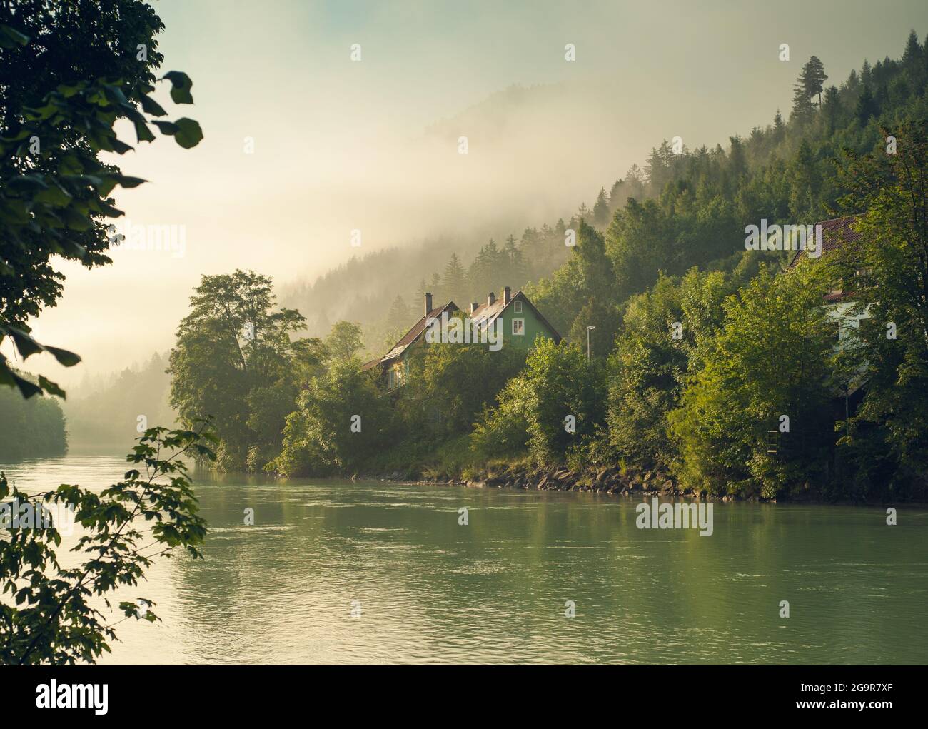 Alps and fog in early morning sun. Landscape with mountains, river ...