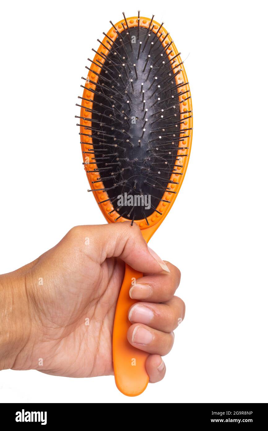 Big hair comb in hand isolated on white background Stock Photo - Alamy