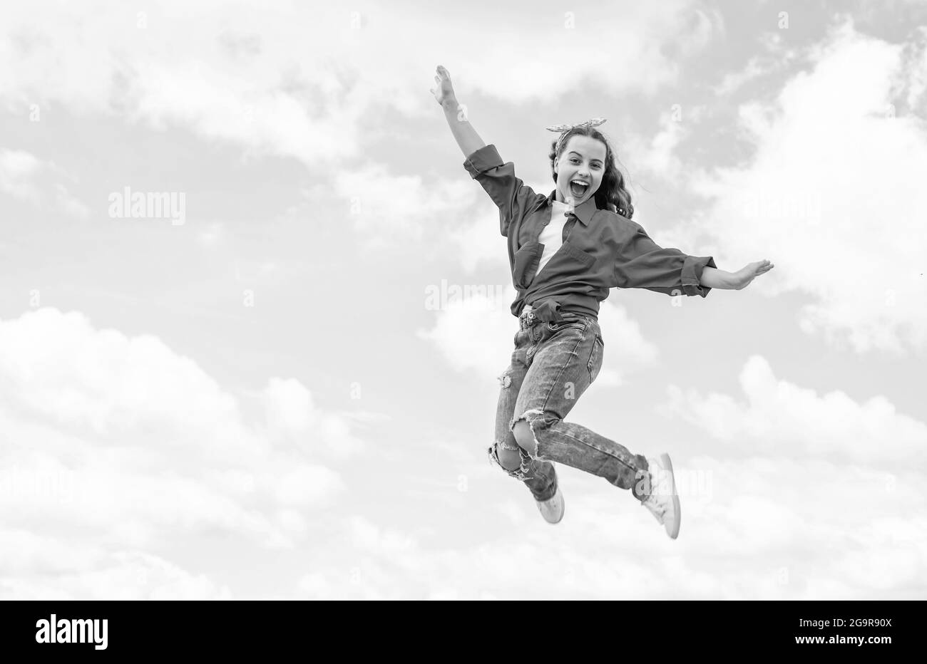 cheerful teen girl jumping high. kid jump outdoor. kid fashion and ...