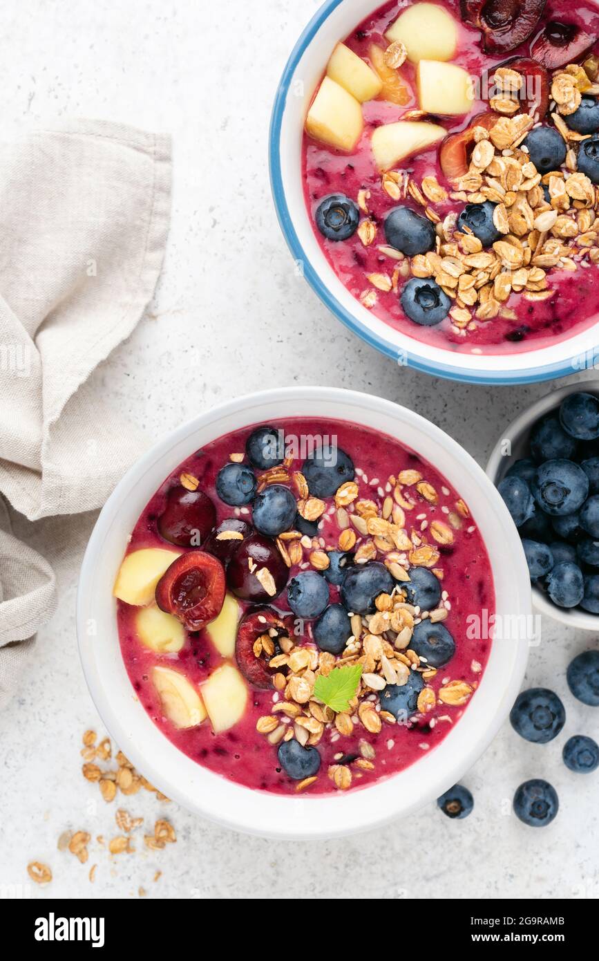 Purple acai smoothie bowls with toppings. Vegan raw acai bowl Stock ...