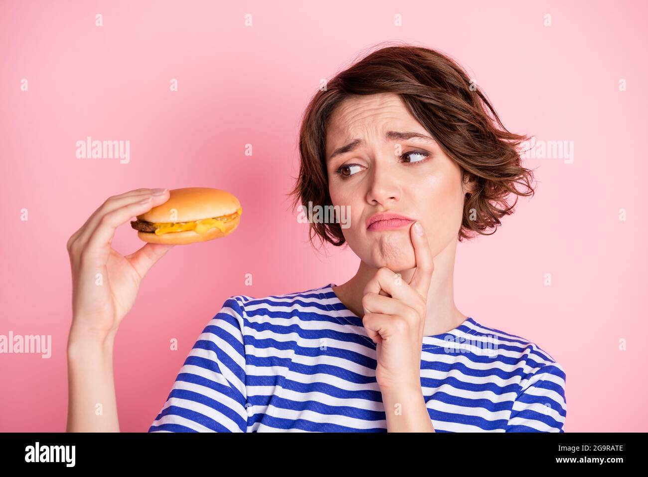 Portrait of young beautiful serious thoughtful minded girl look at ...