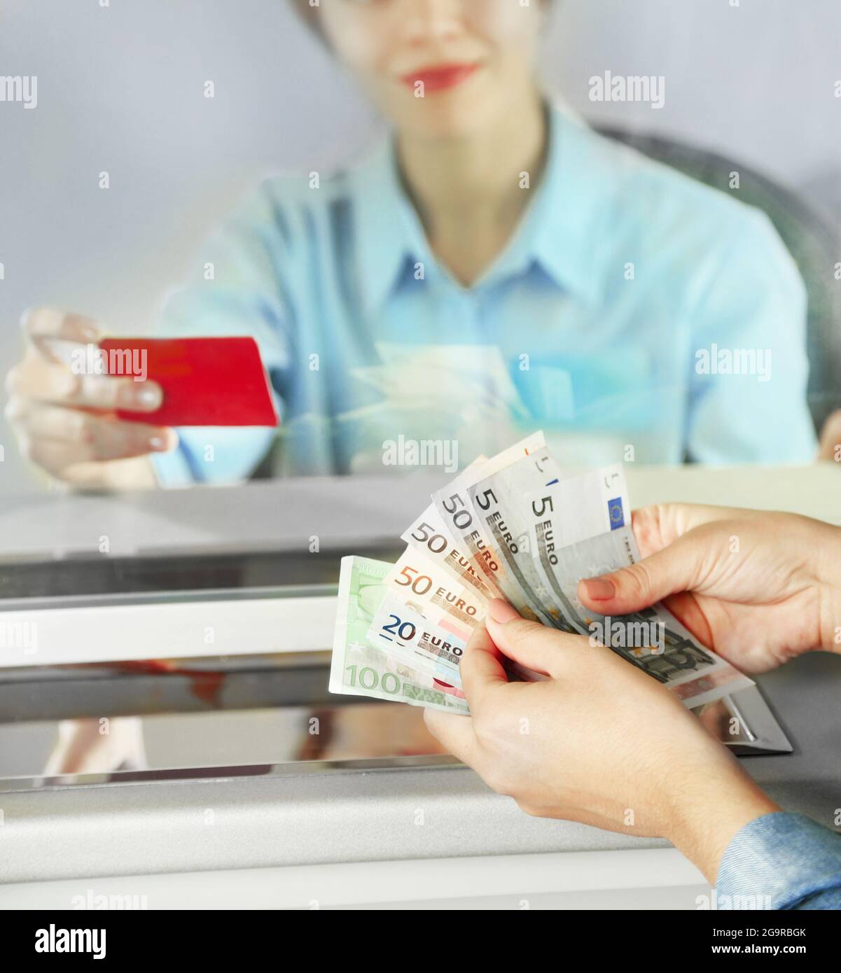 Teller window with working cashier Stock Photo - Alamy