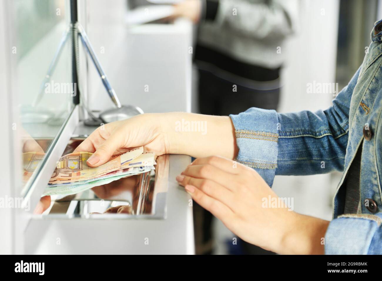 Female hand with money in cash department window. Currency exchange ...