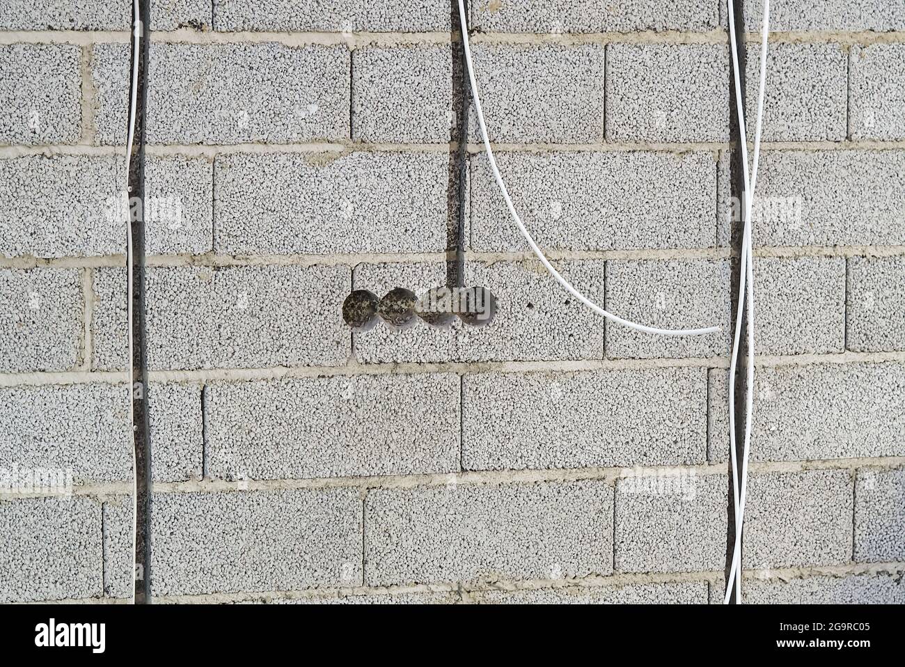 laying of electrics and other engineering systems in a stone wall in a ...