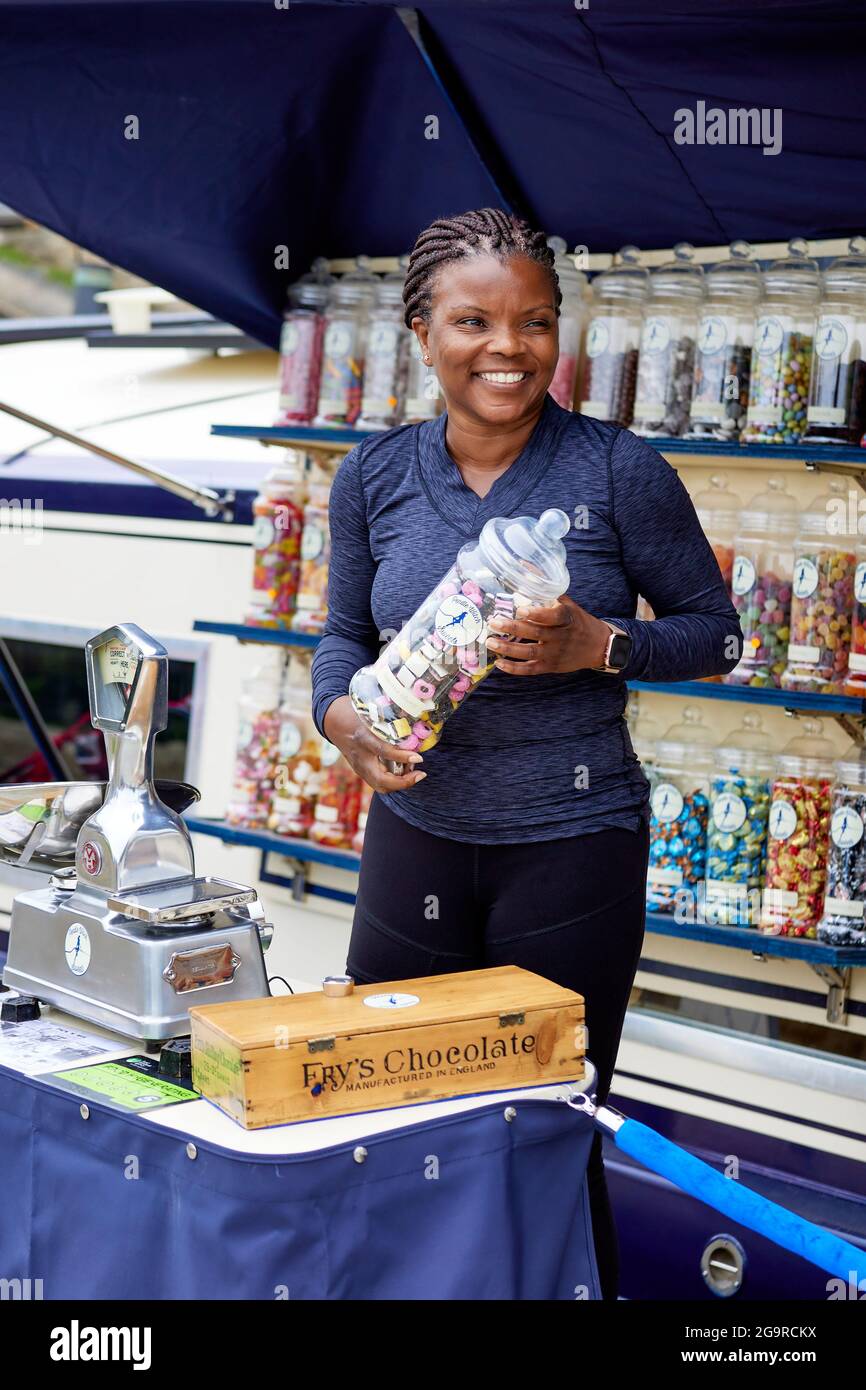 A black woman selling her candy at a market stall Stock Photo - Alamy