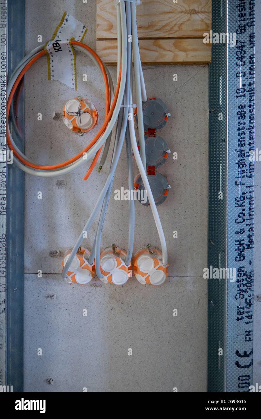 in the drywall run the power cables for the sockets Stock Photo - Alamy