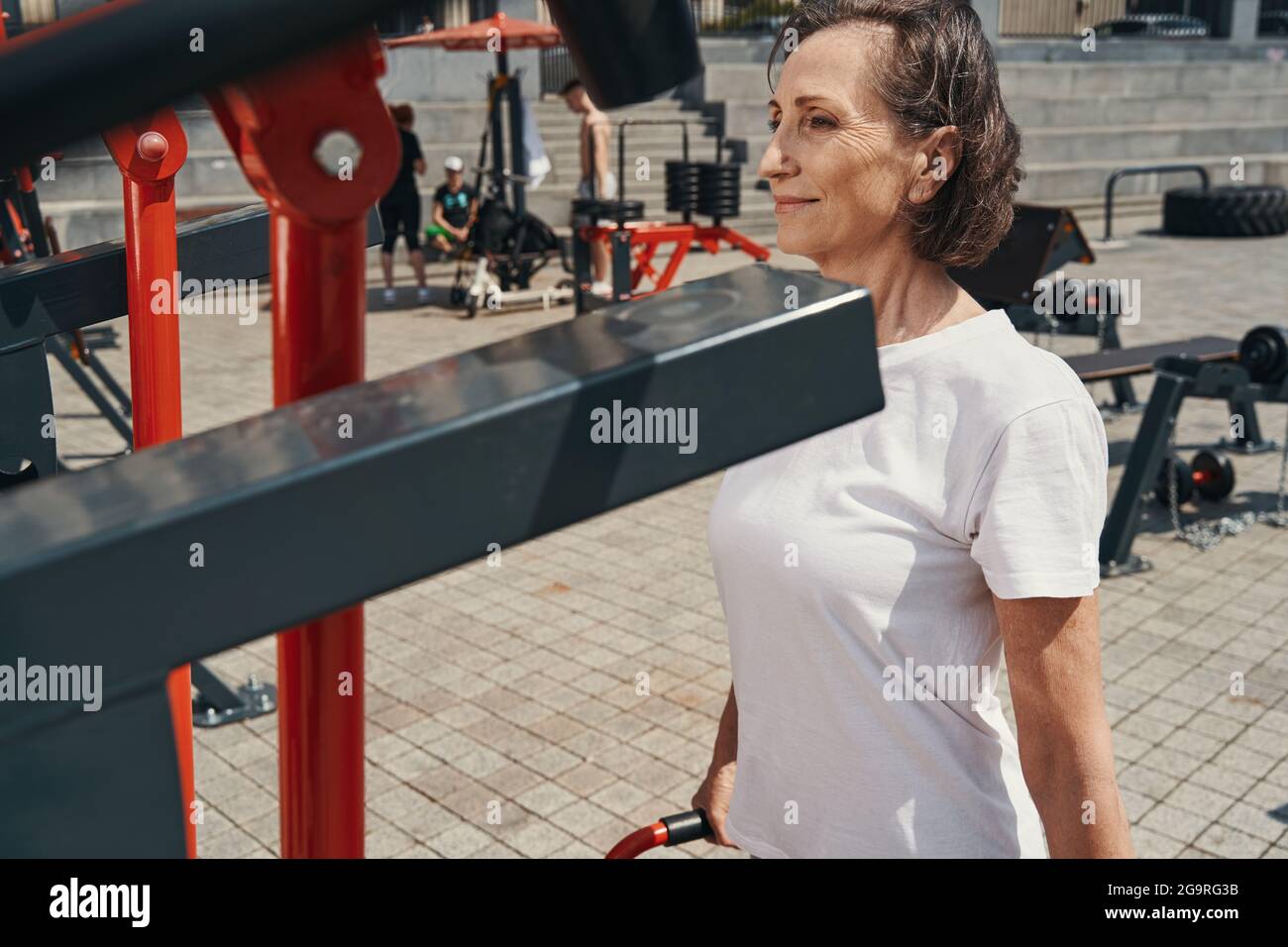 Smiling active woman doing workout in open air Stock Photo - Alamy