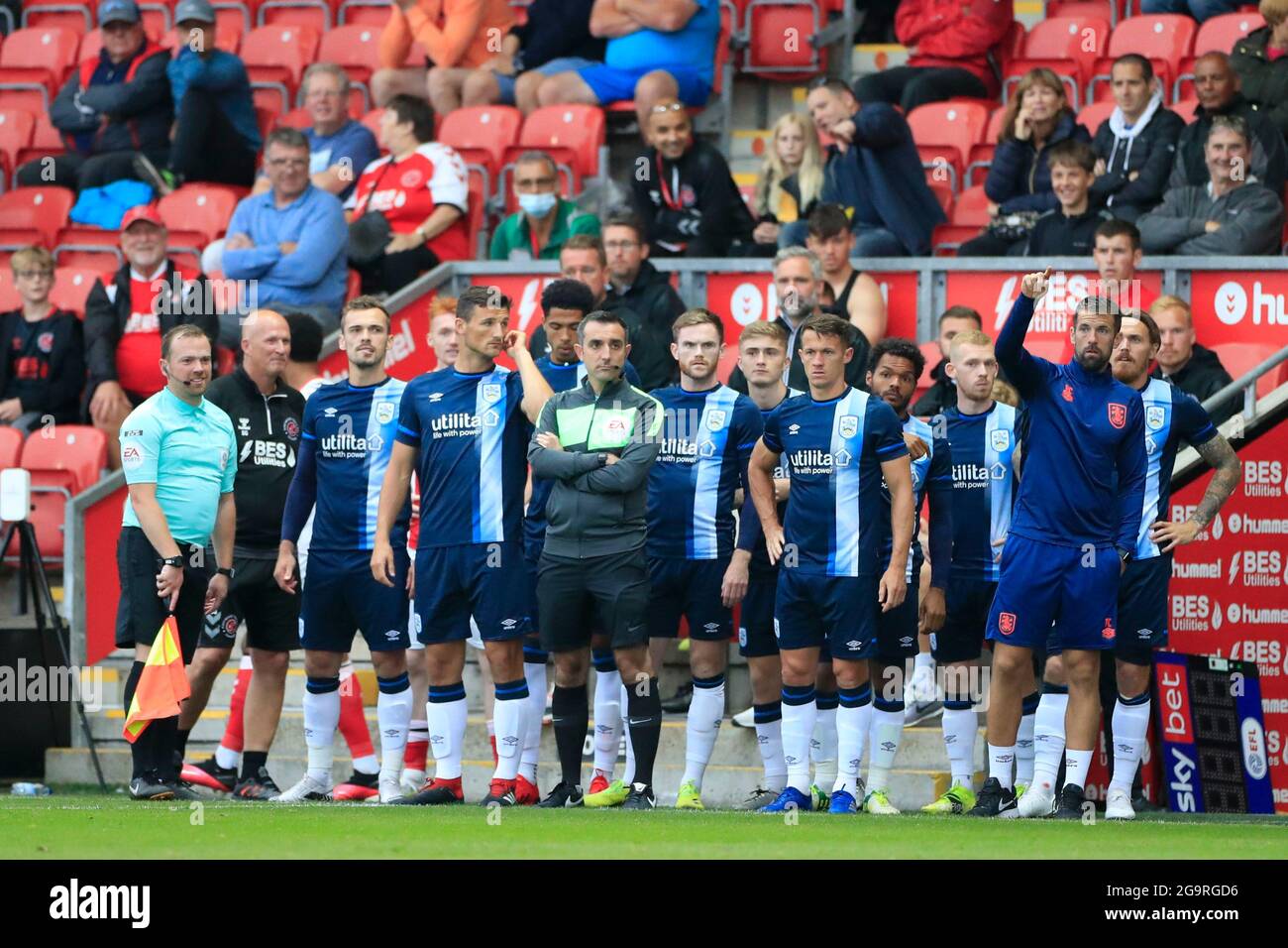 Fleetwood, UK. 27th July, 2021. Huddersfield substitutes line up to ...