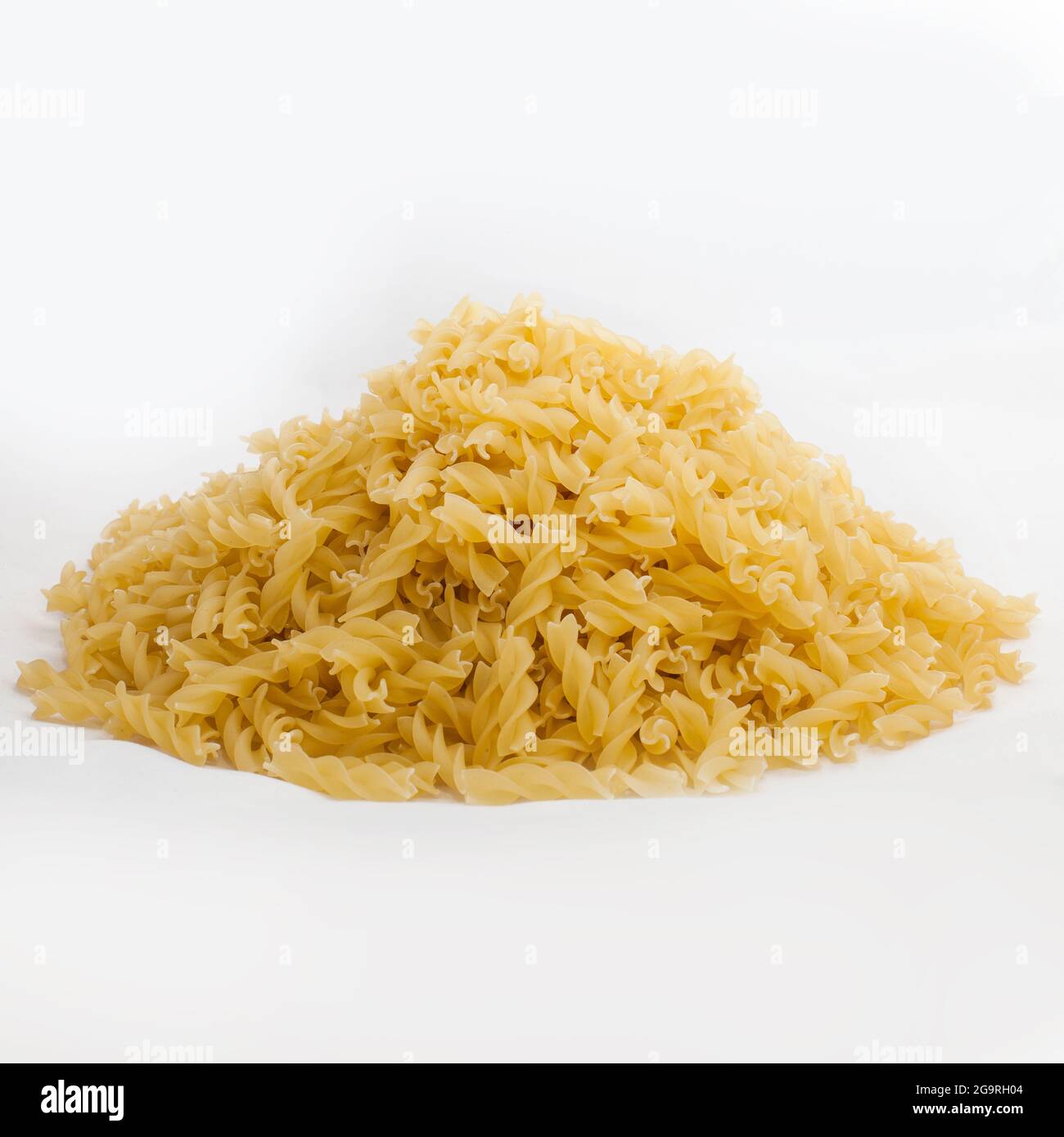 Italian spiral pasta texture with selective focus, white studio ...
