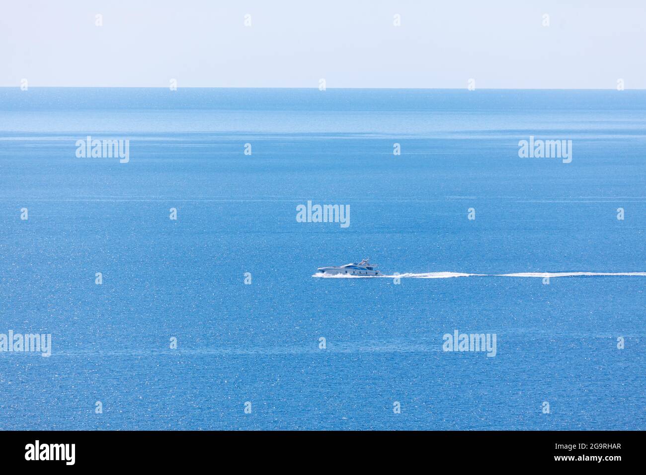 Speed boat on the blue water . Fast boat sailing . Trail on the water ...