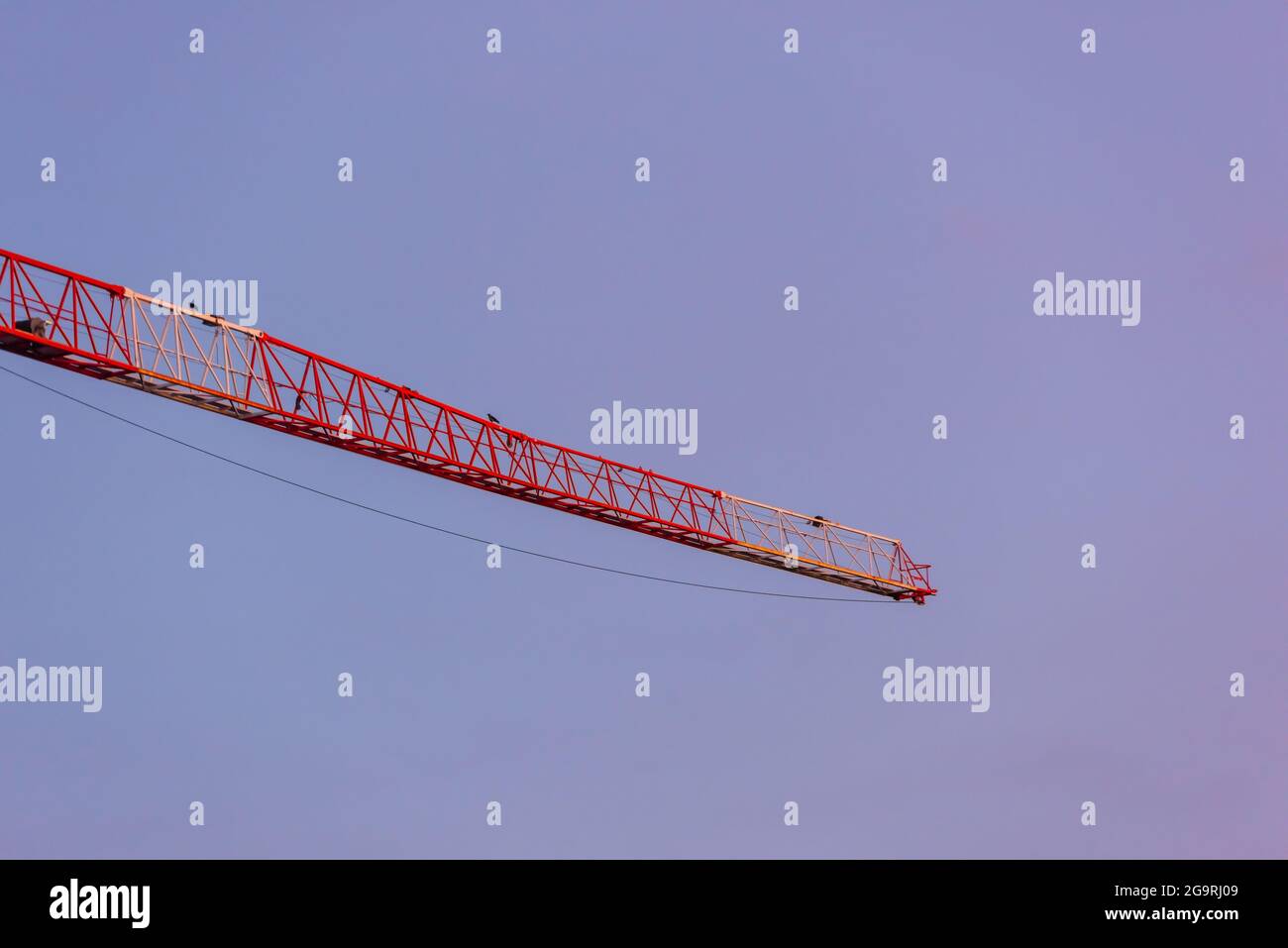 Red and white boom of a construction crane Stock Photo - Alamy