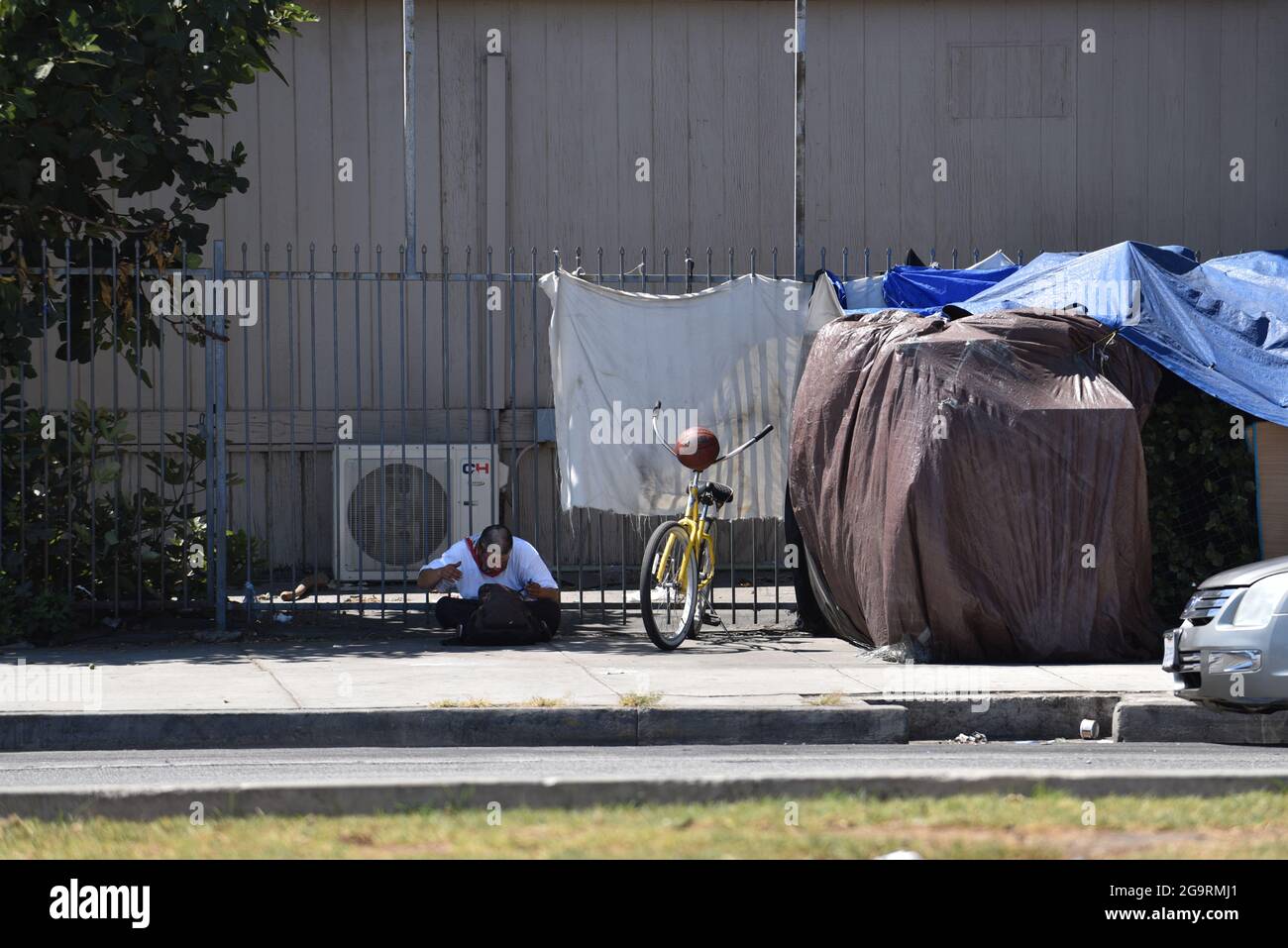 Los Angeles, CA USA - June 30, 2021: Homeless man and tent under a ...
