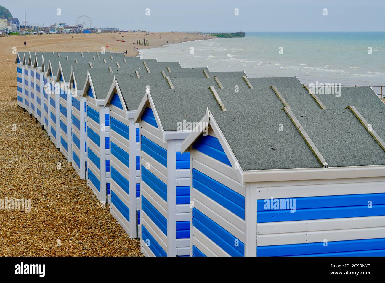 Beach huts on Hastings beach. Thes brightly coloured blue and white ...