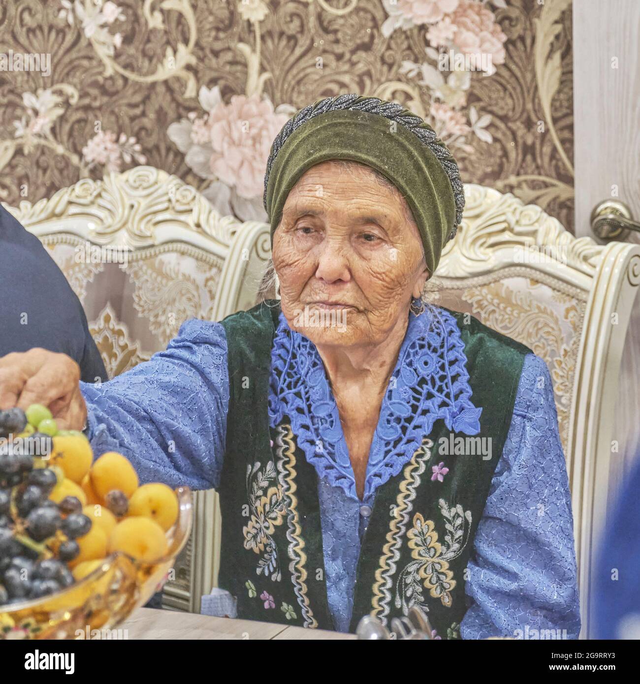 Elderly woman in festive clothes. Local residents of Siberian village ...