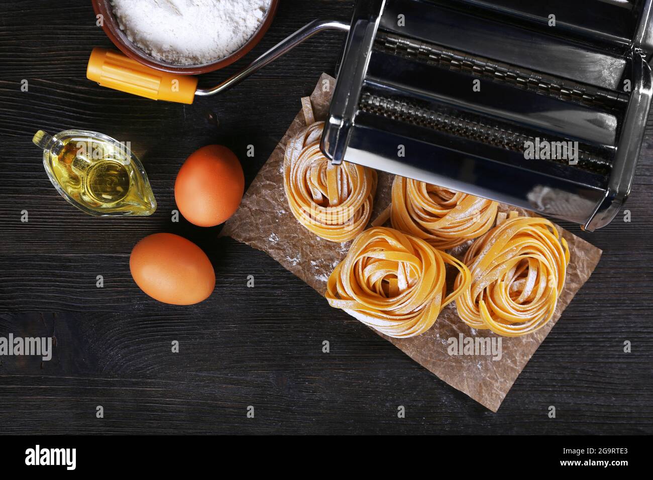 Preparing pasta by pasta machine on rustic wooden background Stock ...