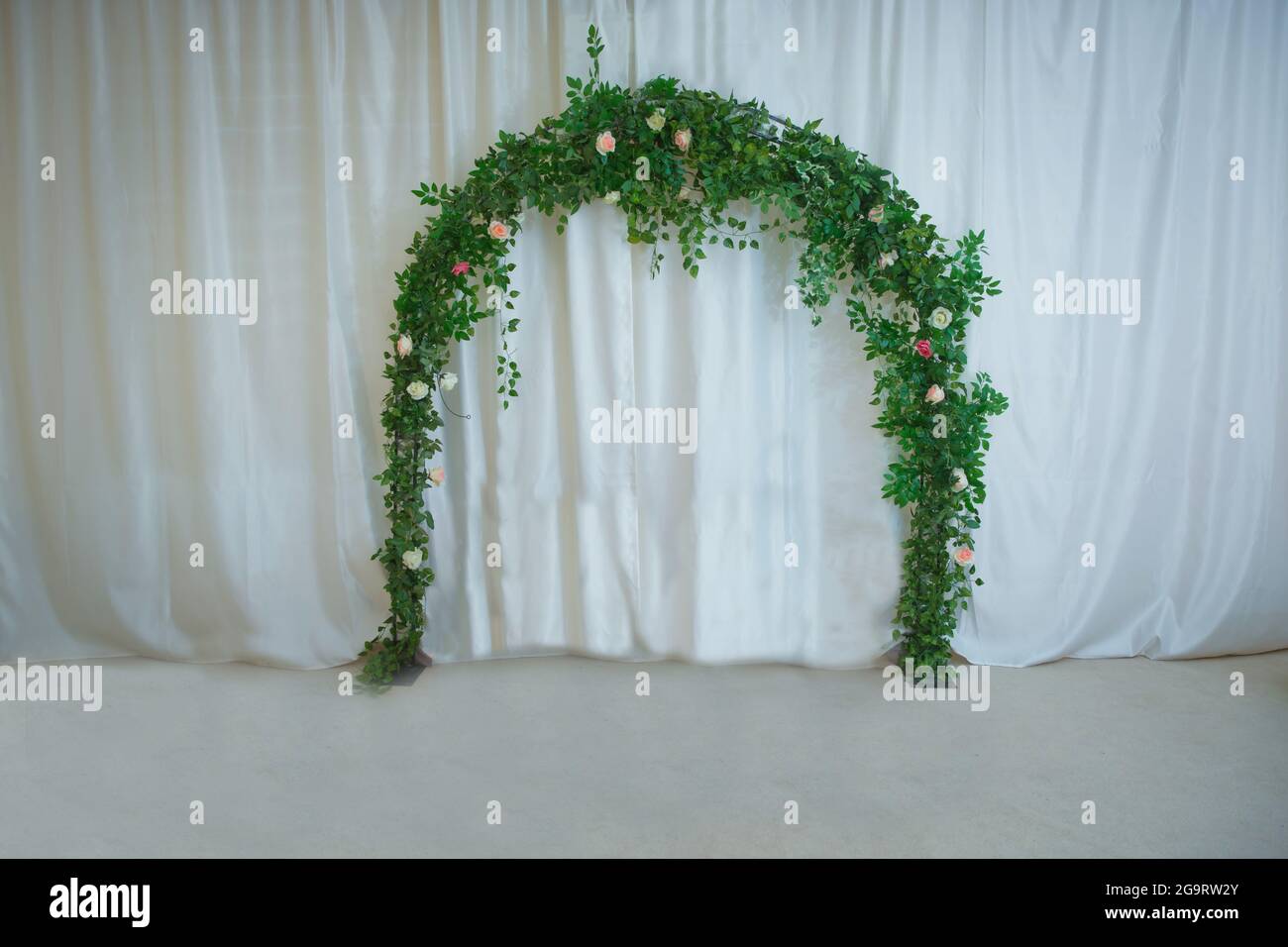 flower arch with flowers, branches and green leaves . Beautiful wedding ...