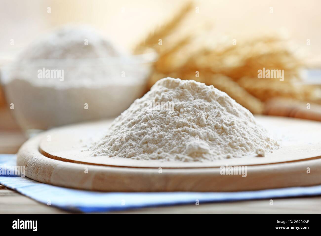 Pile of flour on wooden cutting board and blurred background Stock ...