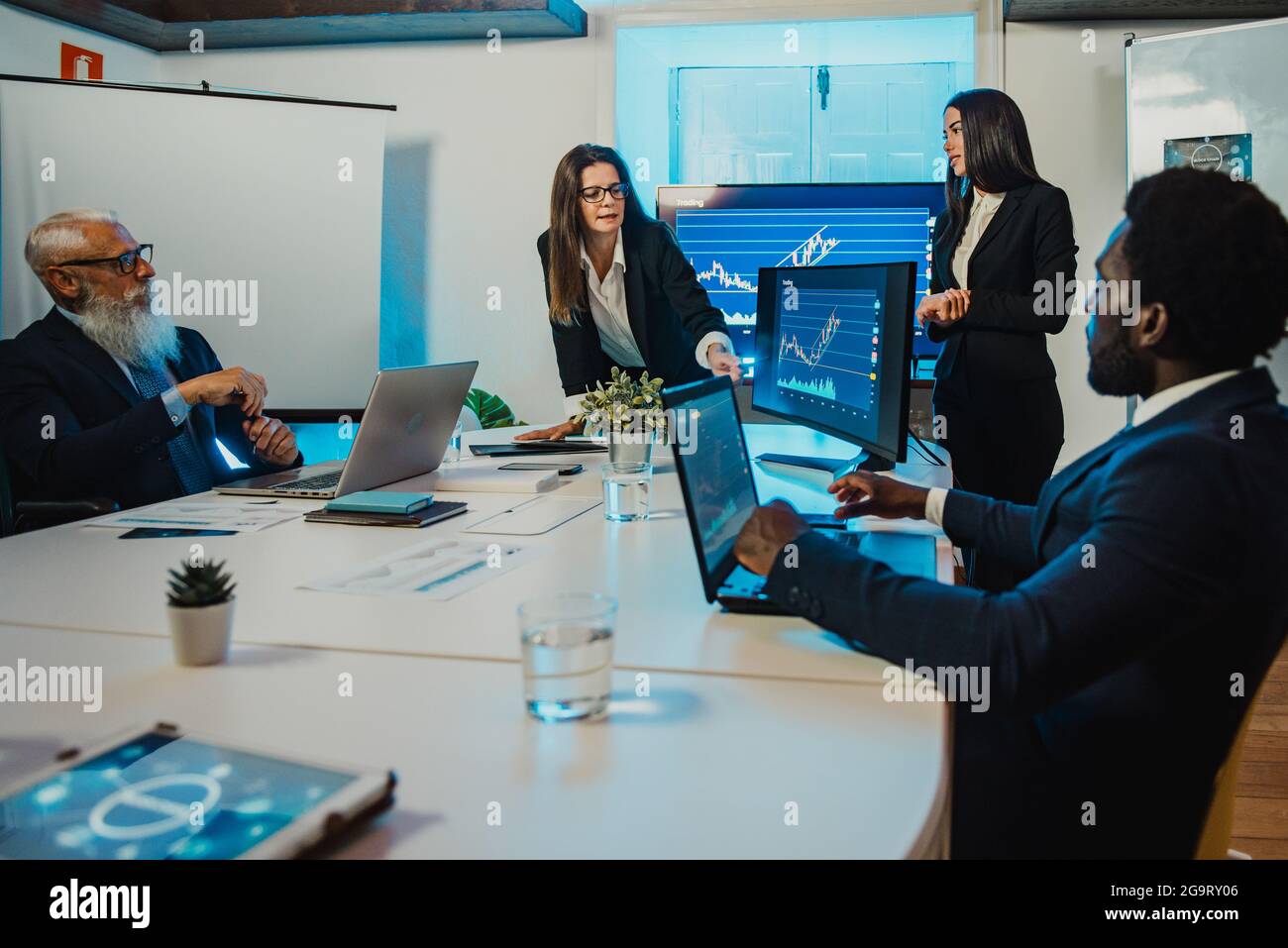 Diverse businesspeople discussing data in boardroom Stock Photo - Alamy