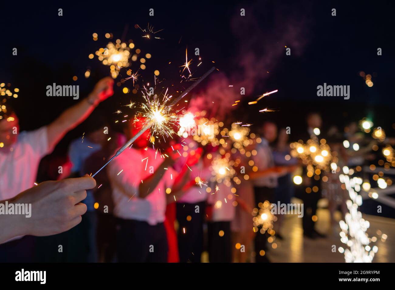 Picture showing group of friends having fun with sparklers Stock Photo ...
