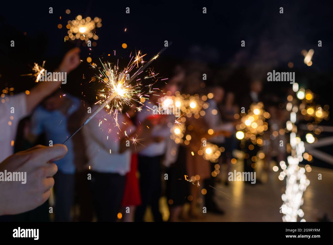 Picture showing group of friends having fun with sparklers Stock Photo ...