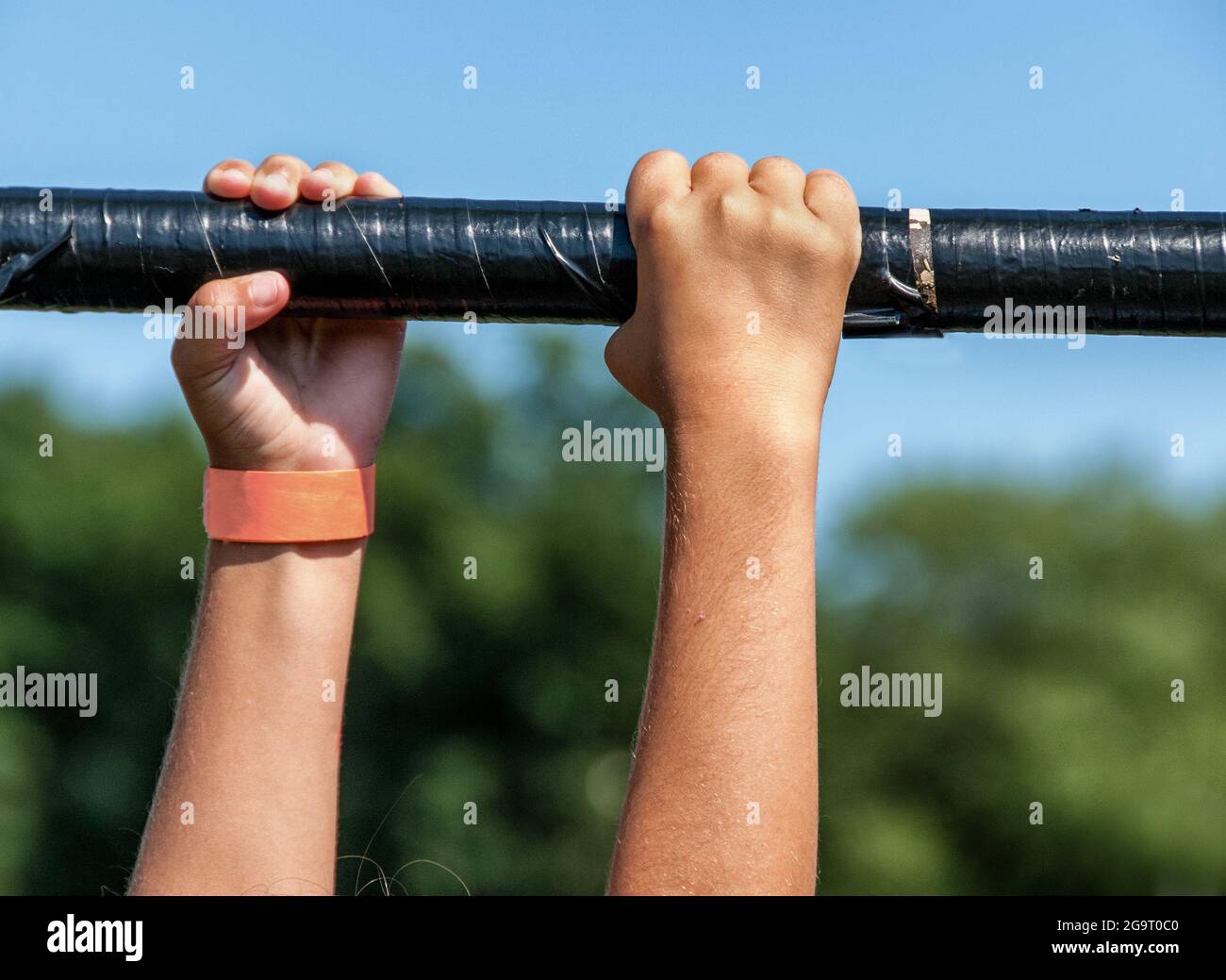 Active youth: Child using a pull up bar Stock Photo - Alamy