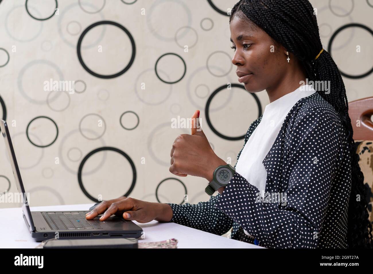 pretty african lady seriously working on her system about the days work ...