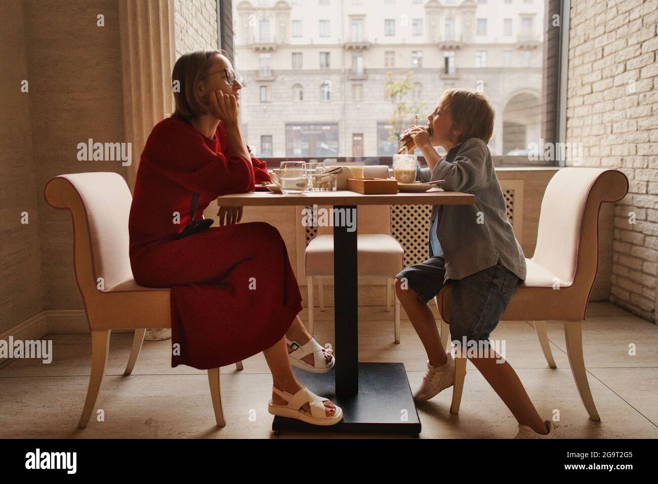 young mom having coffee with her son in street cafe Stock Photo - Alamy