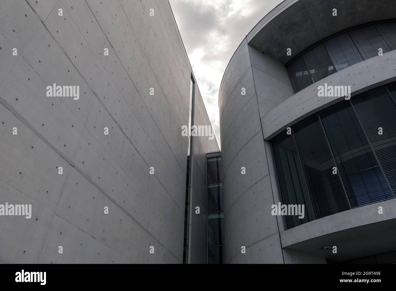 Close-up detail of exterior concrete wall, floor, vertical window with ...