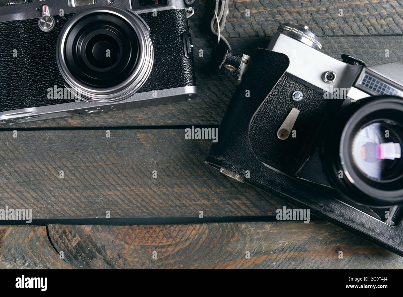 Old retro cameras on rustic wooden planks background Stock Photo - Alamy