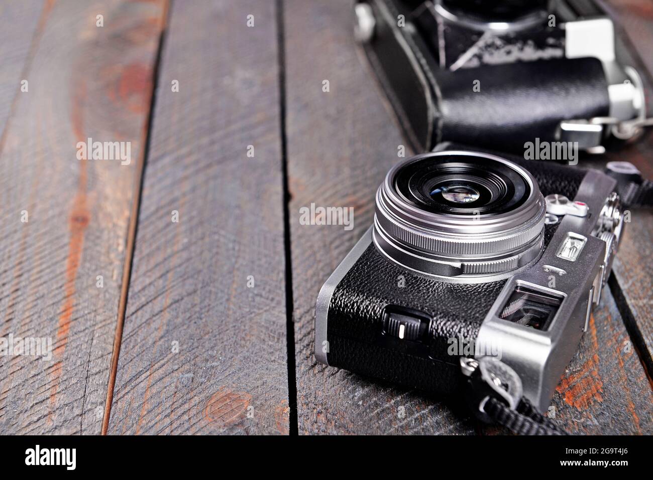 Old retro cameras on rustic wooden planks background Stock Photo - Alamy