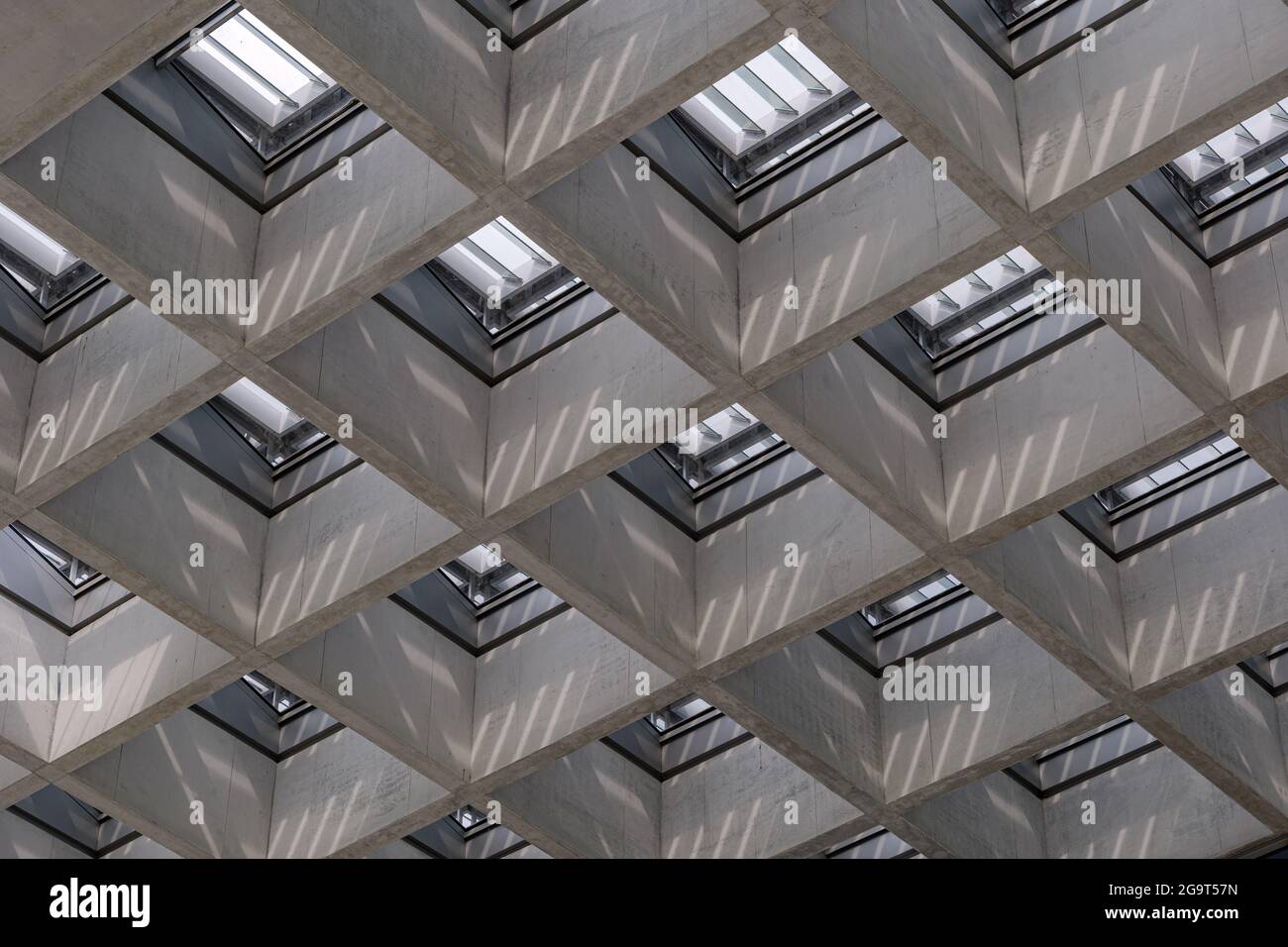 Low angle view of concrete grid beam structure with square louver sky light Stock Photo - Alamy