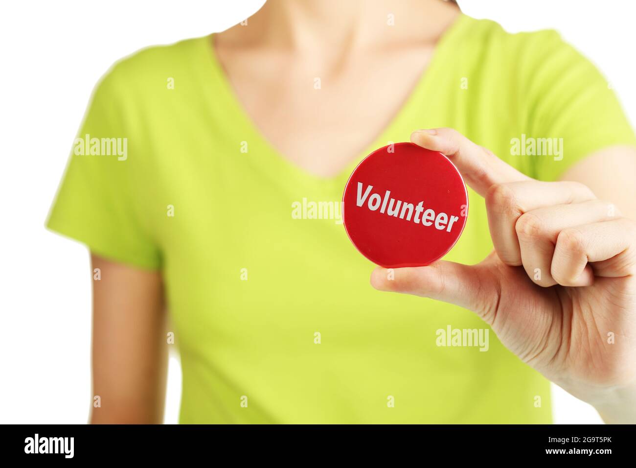 Round volunteer button in hand of girl isolated on white Stock Photo ...