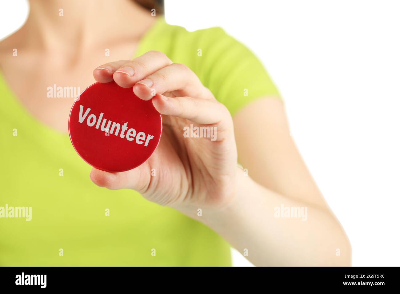 Round volunteer button in hand of girl isolated on white Stock Photo - Alamy
