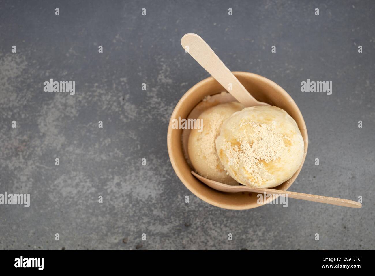Top view Cup of scoop soy based Umami Ice-cream on metal background in ...