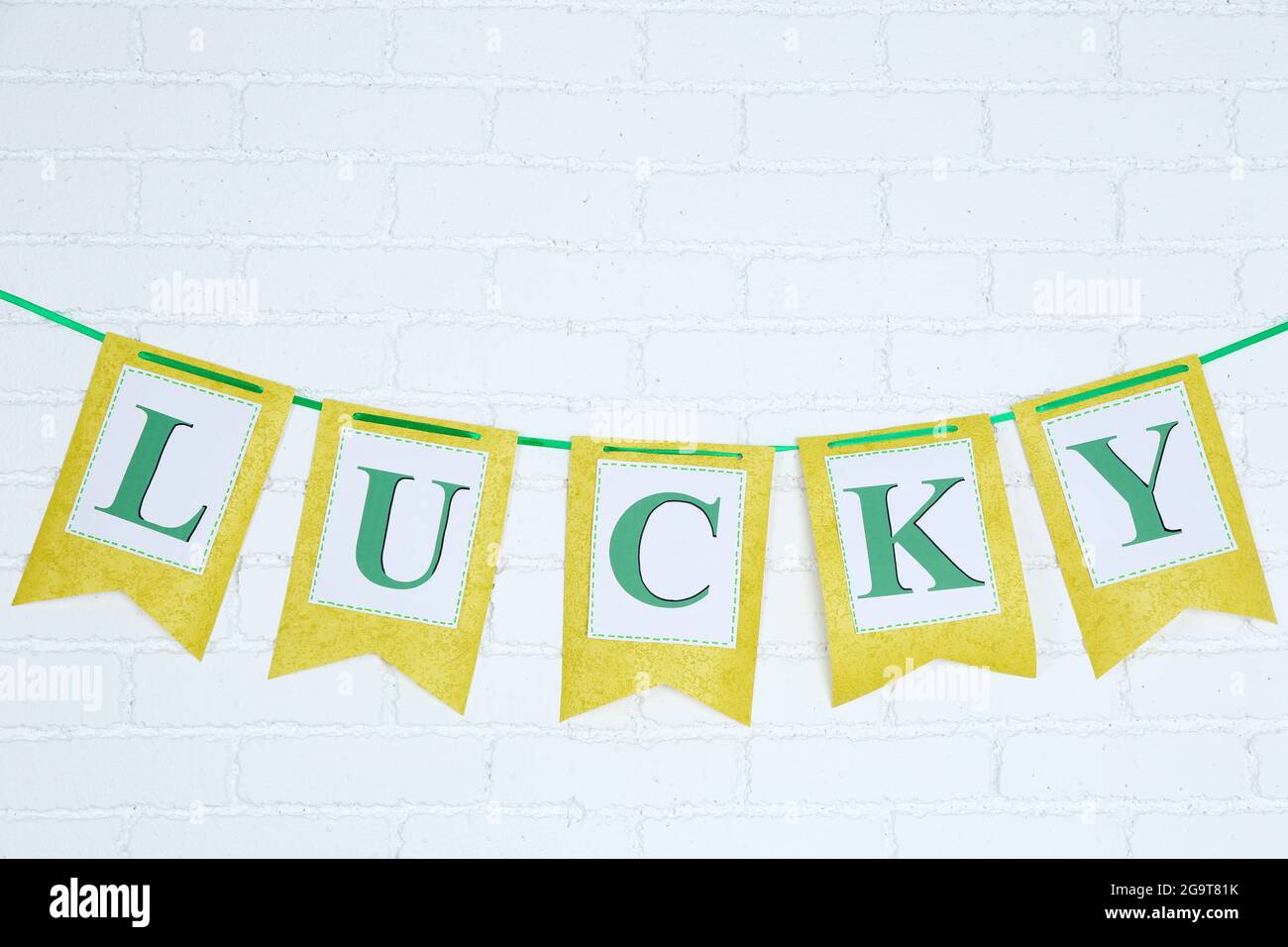 Word Lucky written on paper flags on brick wall background Stock Photo ...