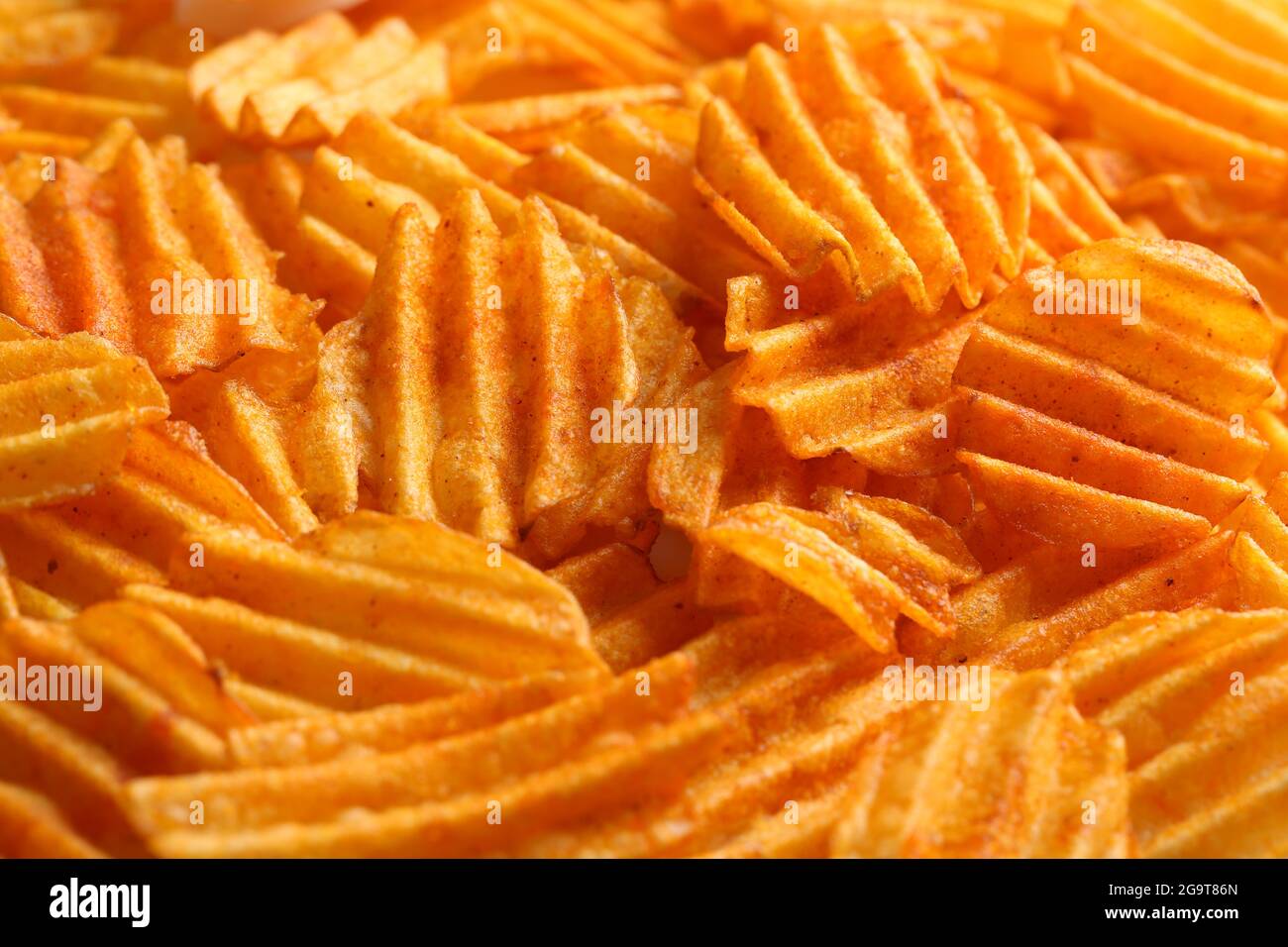 Delicious potato chips closeup background Stock Photo - Alamy