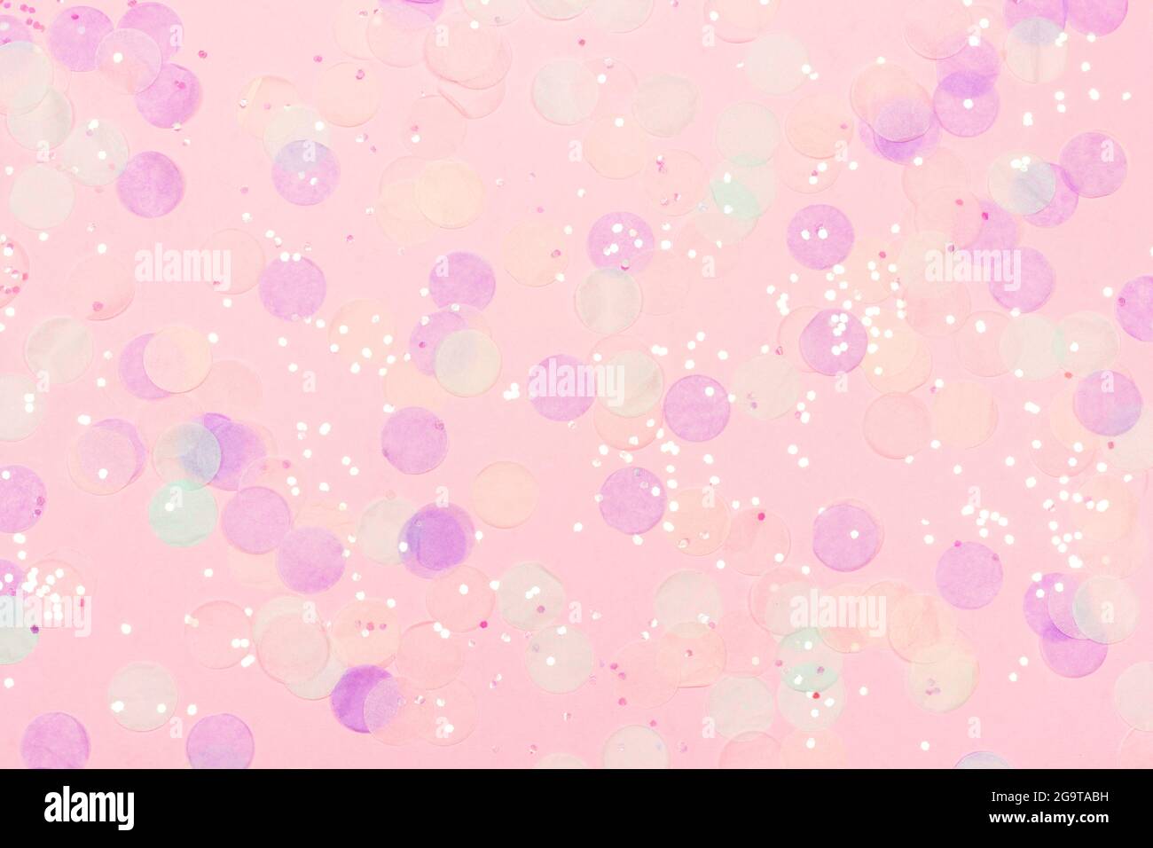 Beautiful pastel pink festive background with confetti. Top view. Copy ...