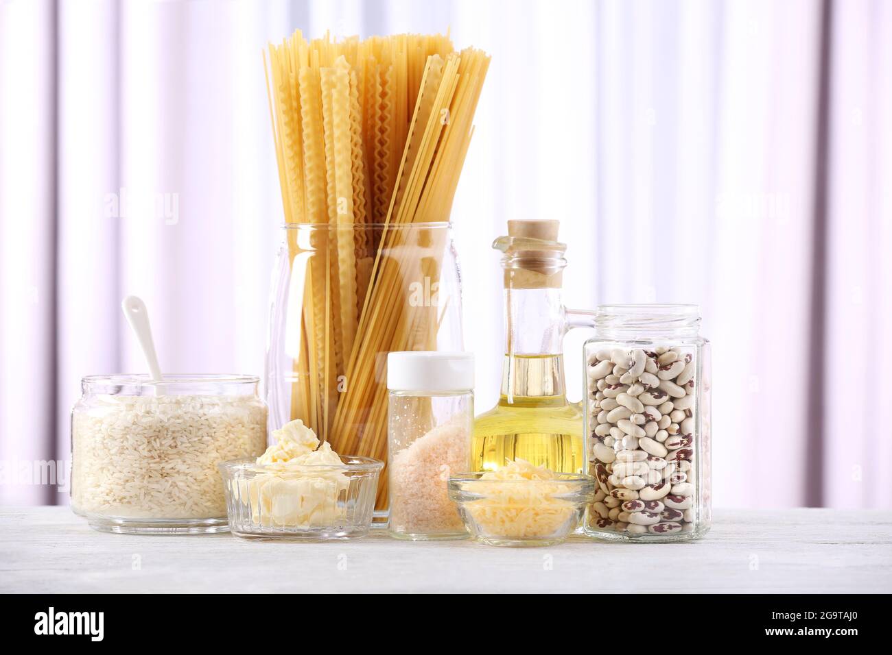 Different products on wooden table on curtain background Stock Photo ...