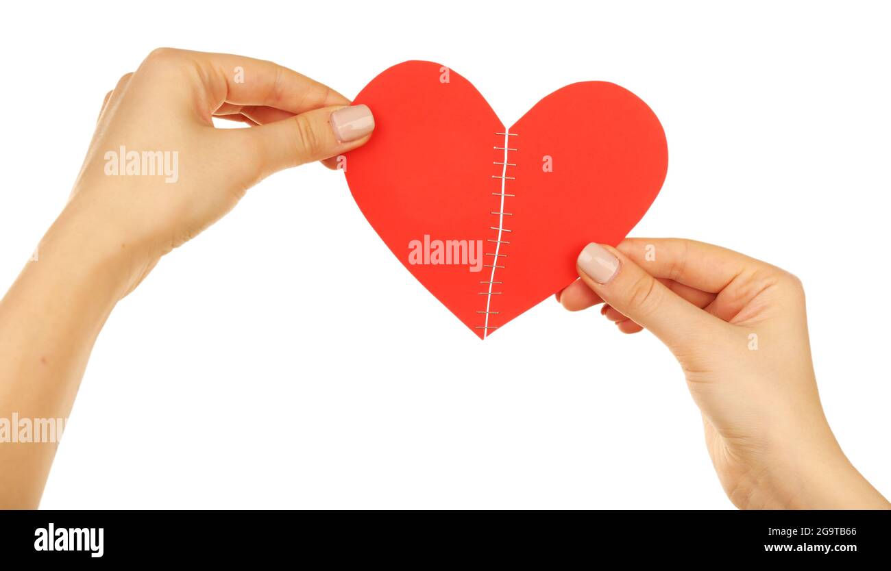 Female hands holding broken heart stitched with staples isolated on ...