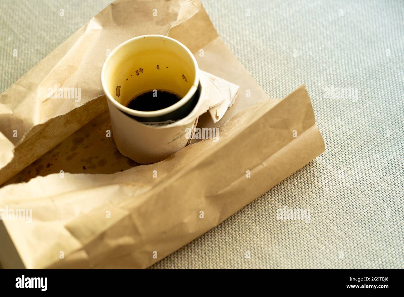 Empty paper coffee cup and a ripped paper bag Stock Photo - Alamy