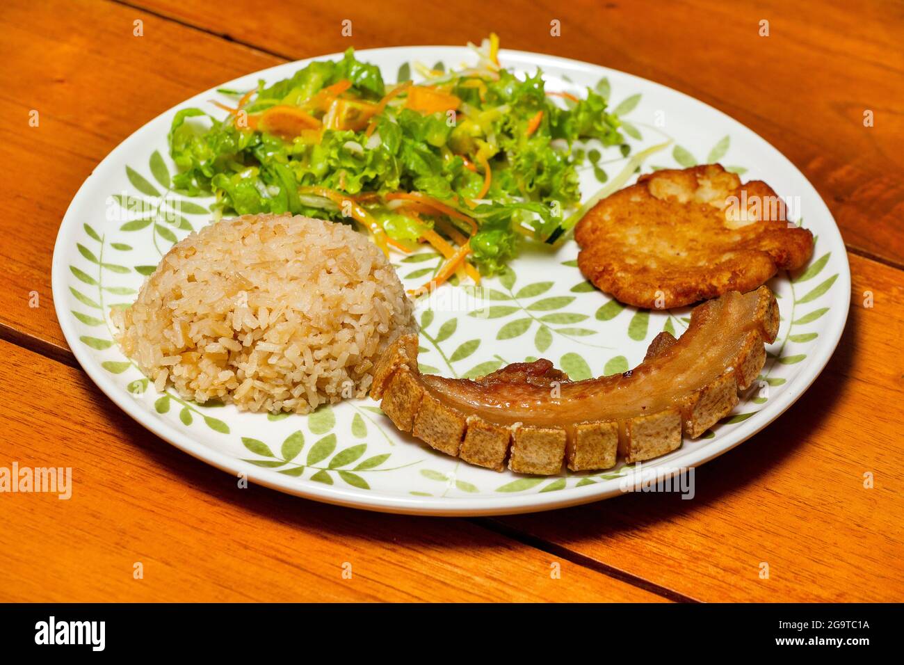 Fried chicharrón with rice and salad, traditional Colombian food Stock ...