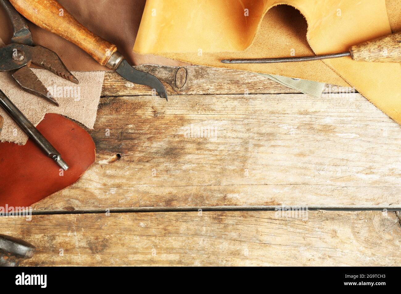 Leather and craft tools on wooden background Stock Photo - Alamy
