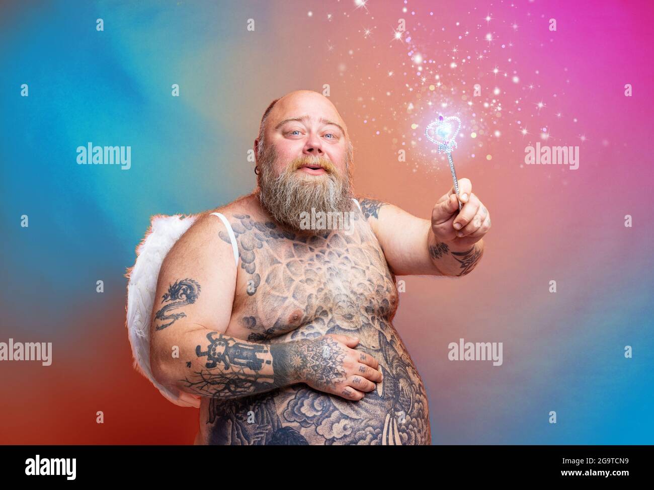 Fat happy man with beard ,tattoos and wings acts like an magic fairy ...